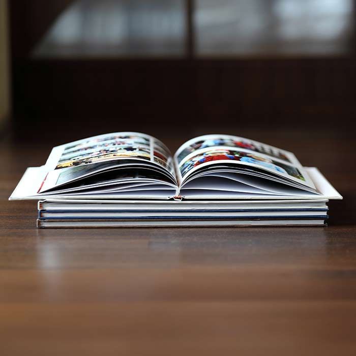 Stack of printed photo albums, press books