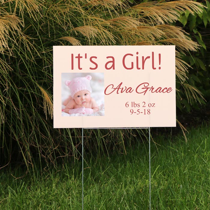 Lawn sign announcing a new baby girl